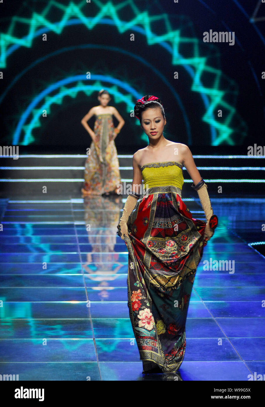 Models wearing garments with Chinese elements pose on the stage during ...