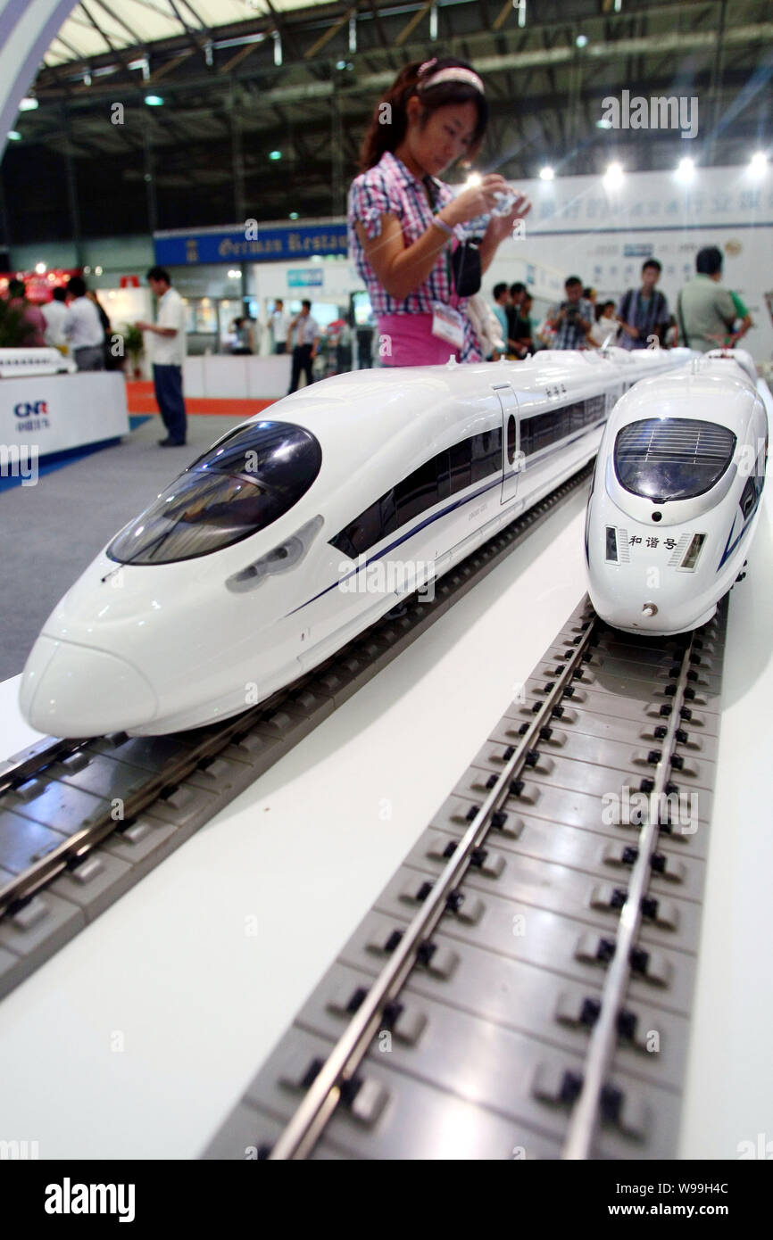 A visitor takes photos of models of CRH (China Railway High-speed ...