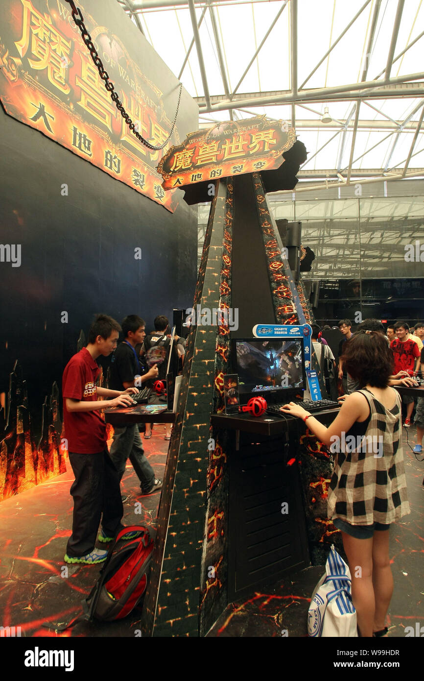 Visitors are playing online game at the booth of World of Warcraft ...