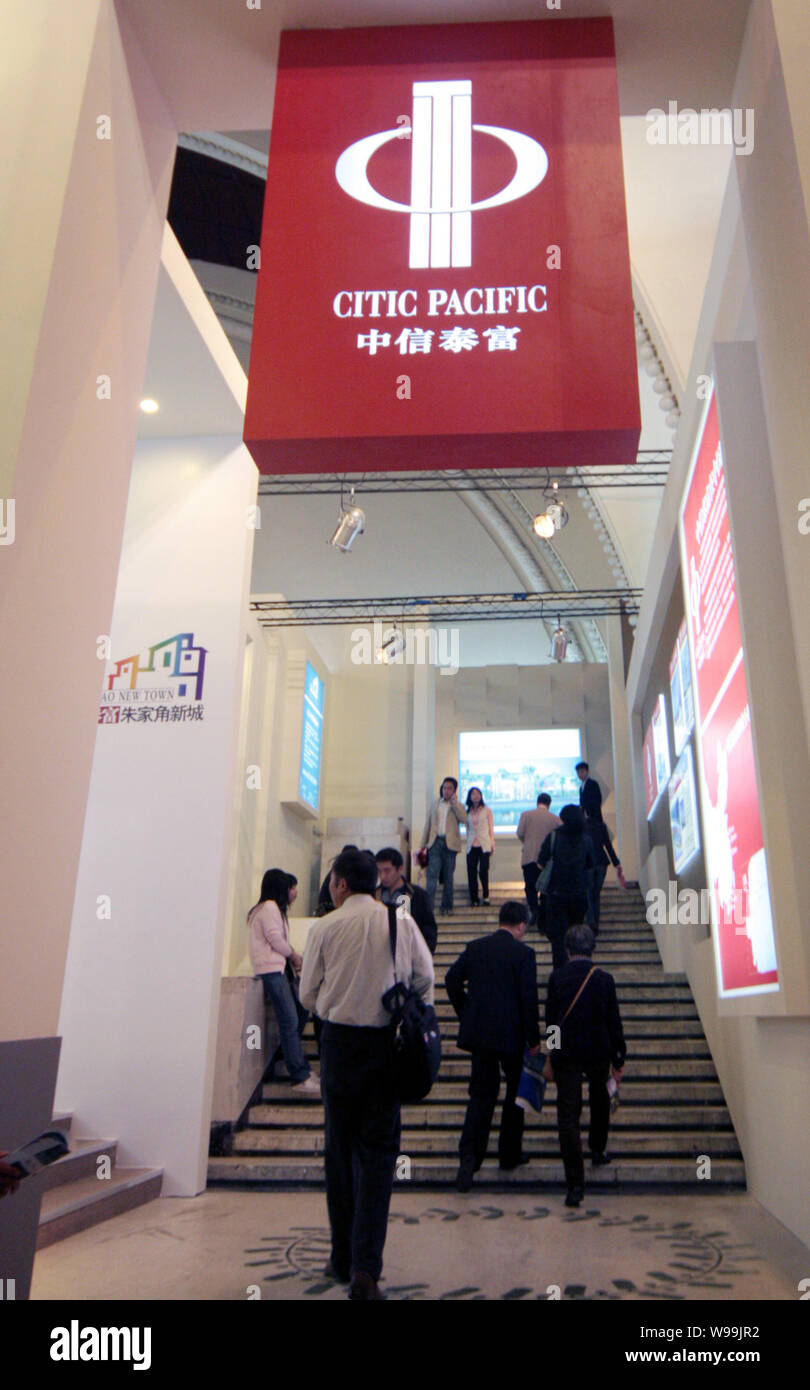 --File-- Visitors walk past an advertisement of Citic Pacific during an ...