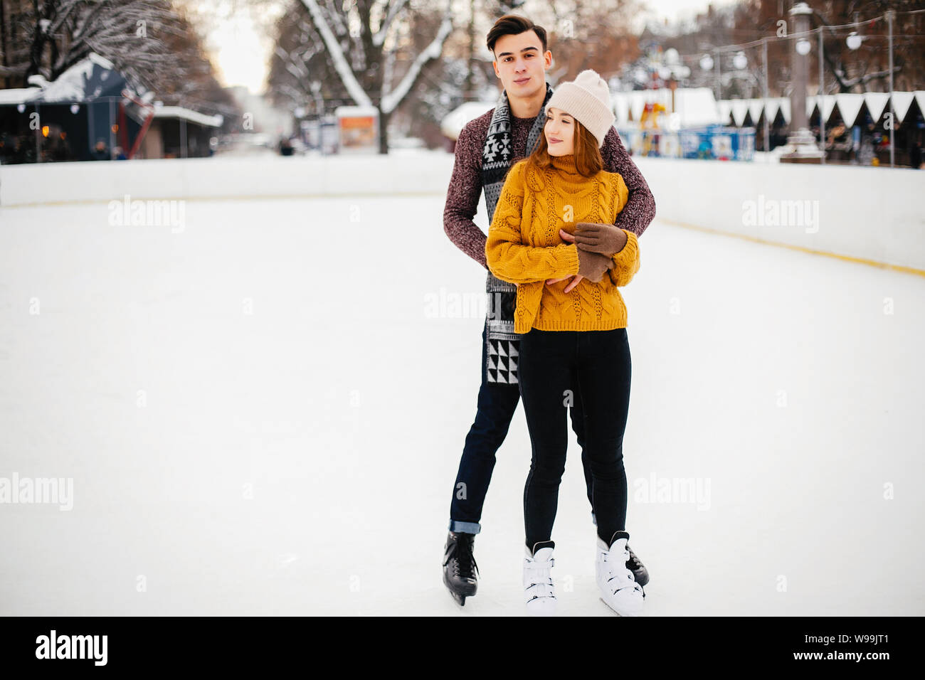 Cute couple in a ice arena Stock Photo - Alamy