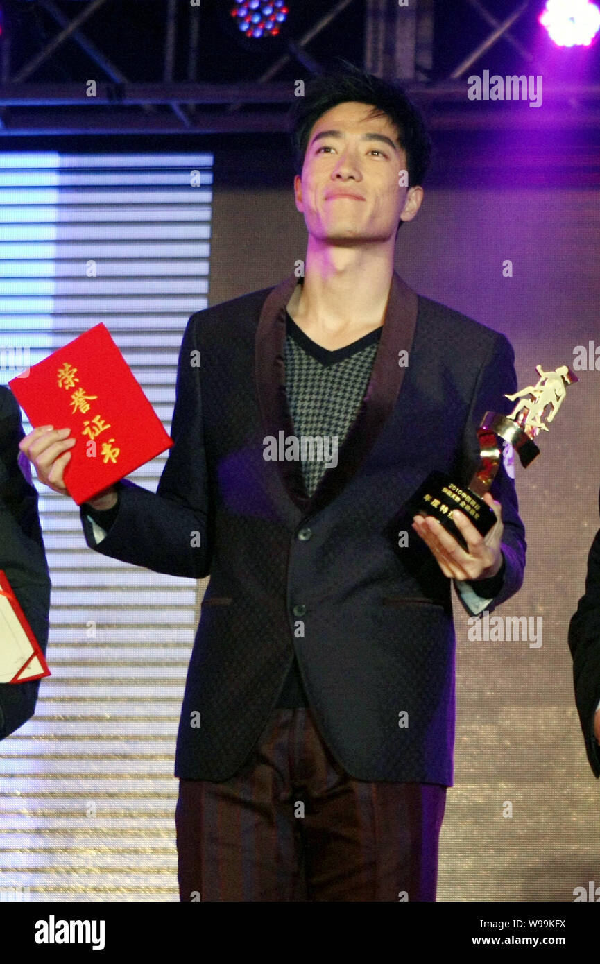 Chinese star hurdler Liu Xiang poses with his trophy during a track and ...