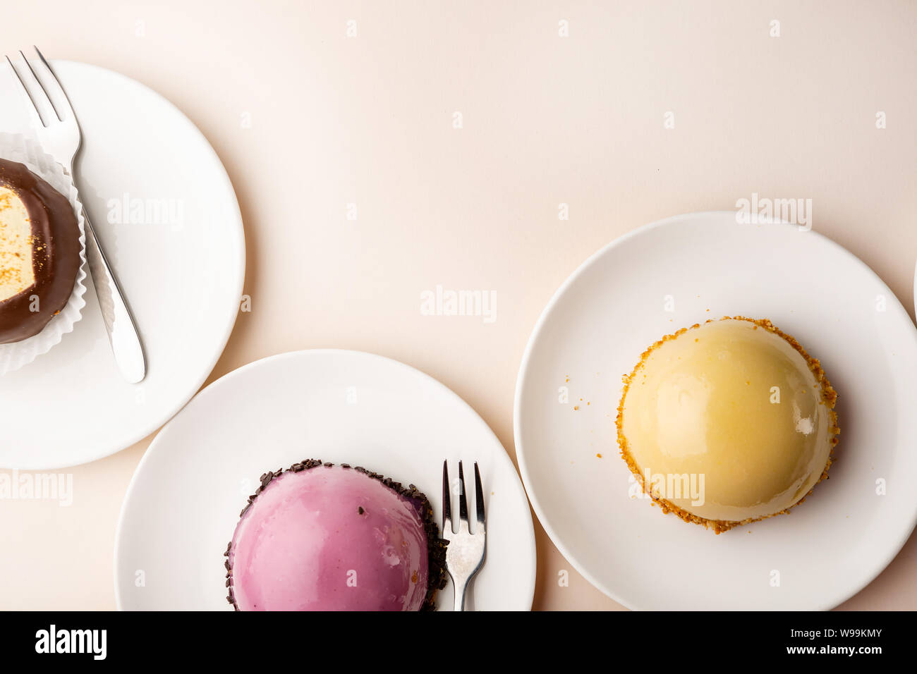Three cake on white plates top view Stock Photo - Alamy