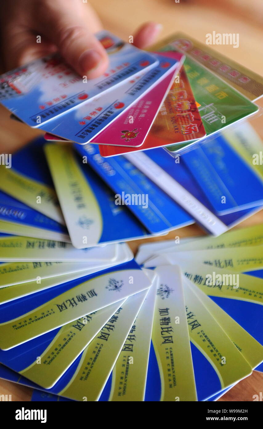 A customer shows different kinds of prepaid cards in Qionghai, south ...