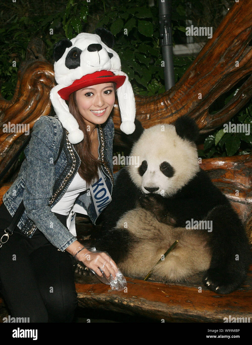 A Beauty Of The 51st Miss International Pageant Poses With A Panda At