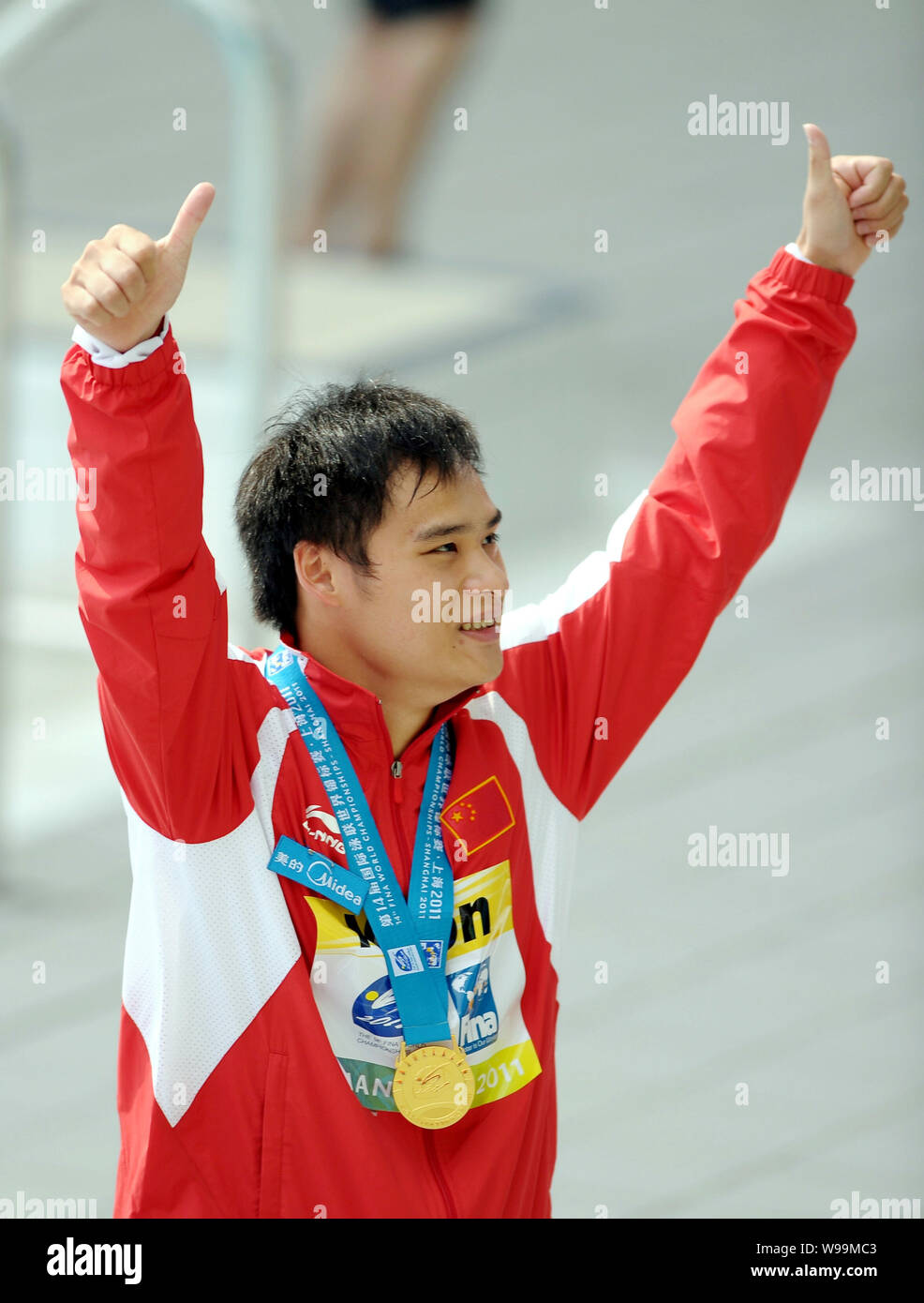 Chinas gold medalist Li Shixin celebrates at the award ceremony for the ...