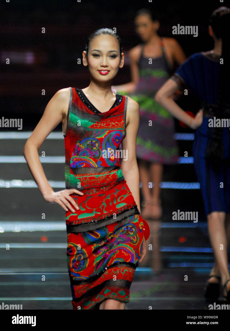 Models wearing garments with Chinese elements pose on the stage during ...