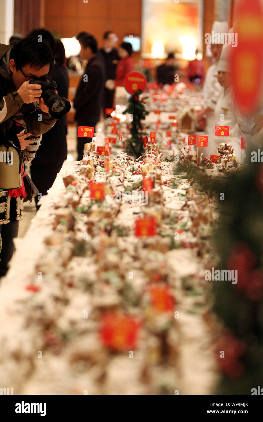 Visitors take photos of the 1,068-meter-long Yule log cake at the ...