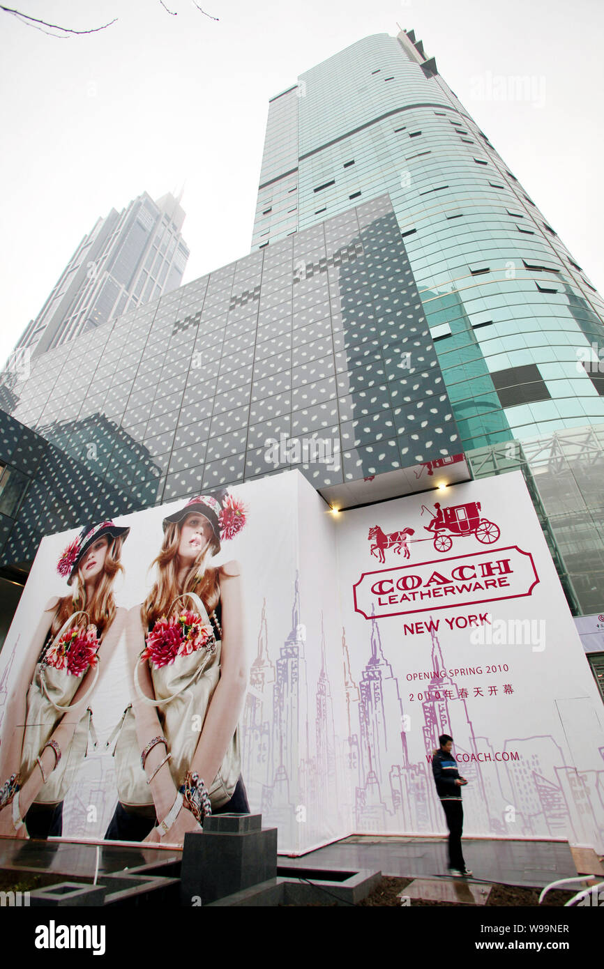 --File--A Chinese man stands in front of an advertisement of the ...