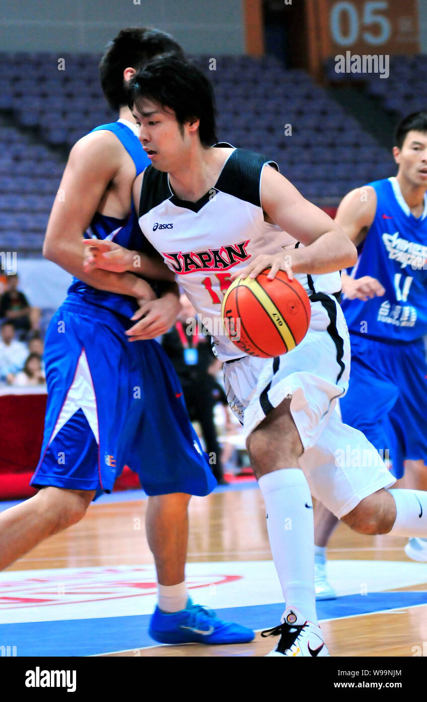 Joji Takeuchi of Japan, right, tries to break through a player of ...
