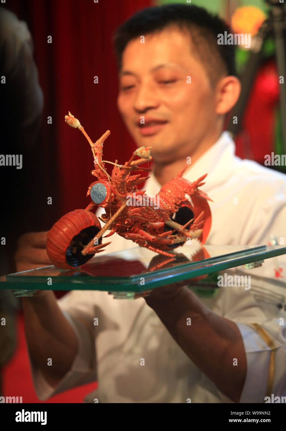 Taiwanese chef Huang Mingbo demonstrates a lobster motorcycle at a ...