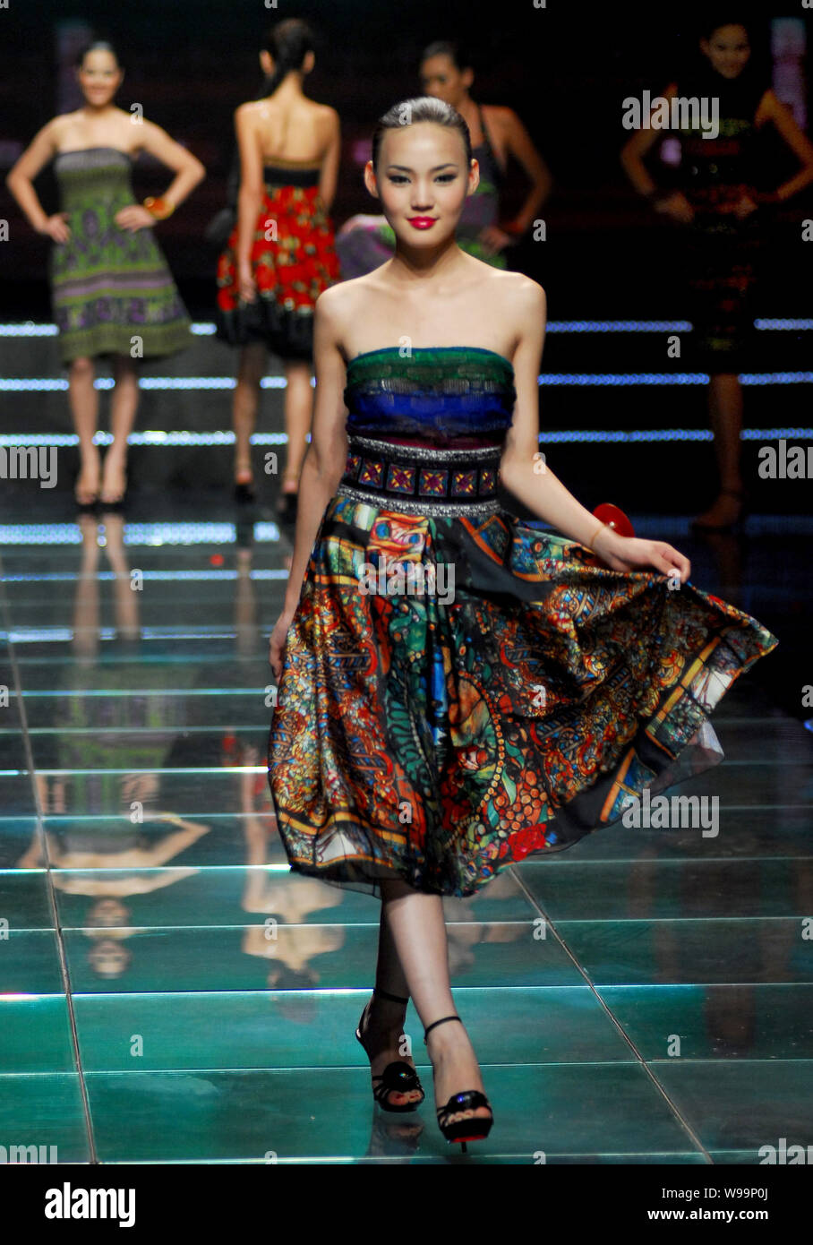 Models wearing garments with Chinese elements pose on the stage during ...