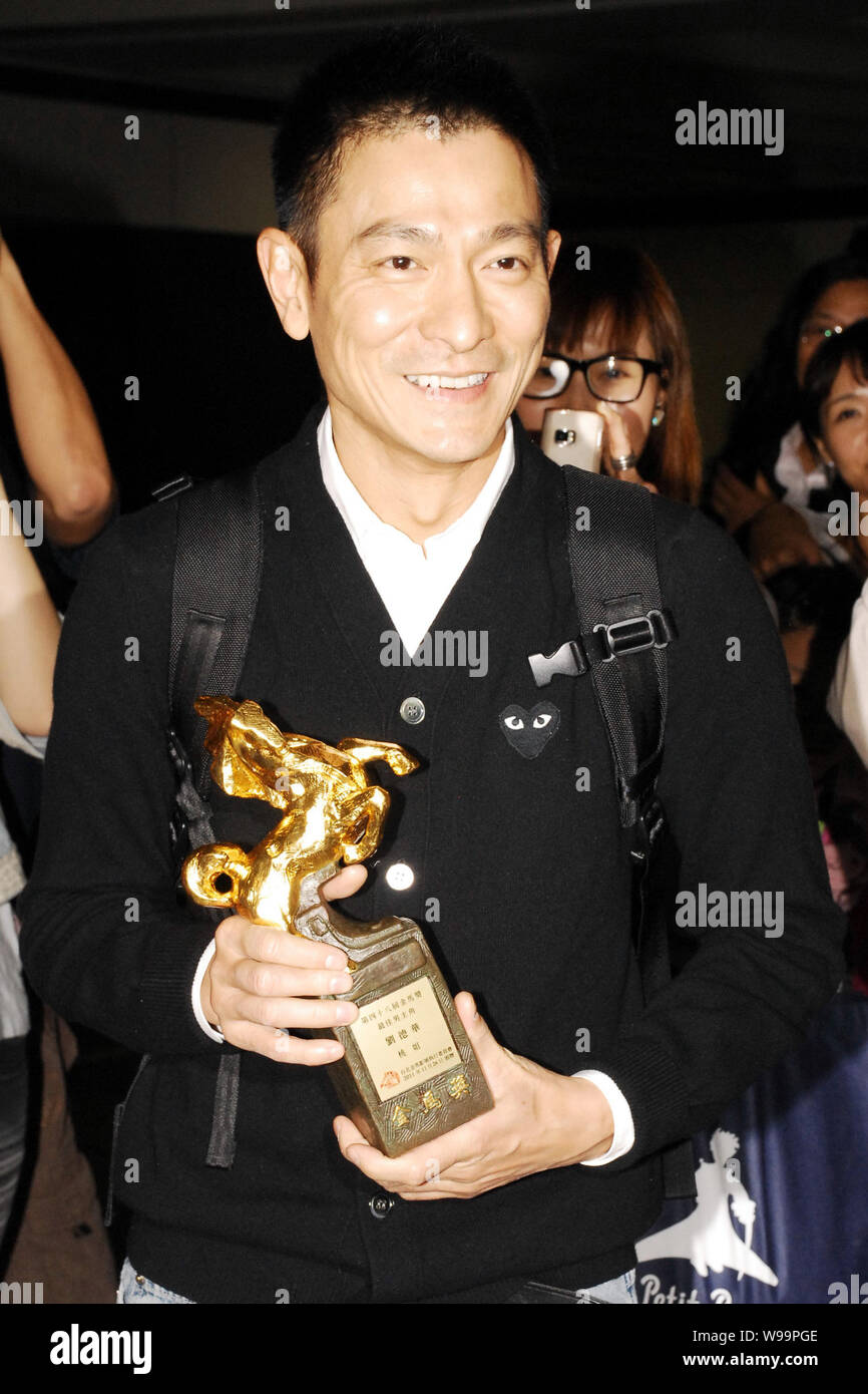 Hong Kong singer and actor Andy Lau holds his trophy for the Best Actor ...