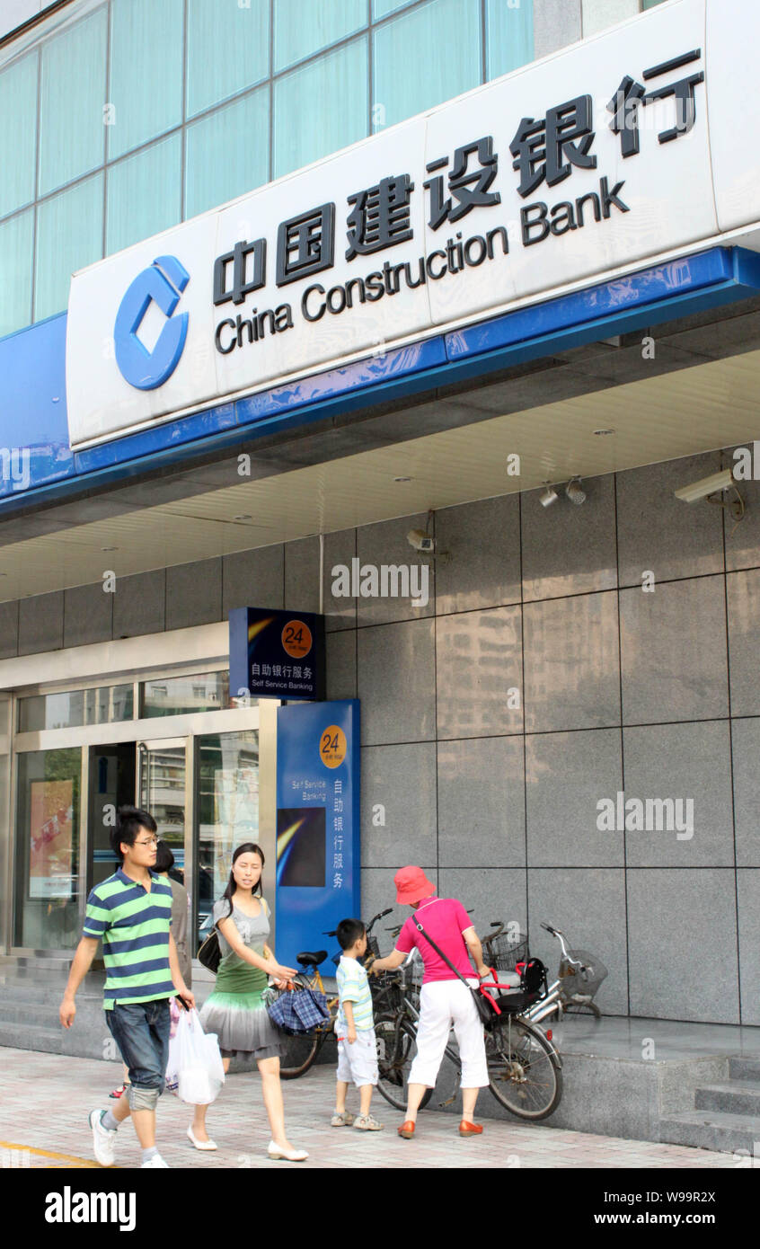 --File--Pedestrians walk past a branch of China Construction Bank (CCB ...