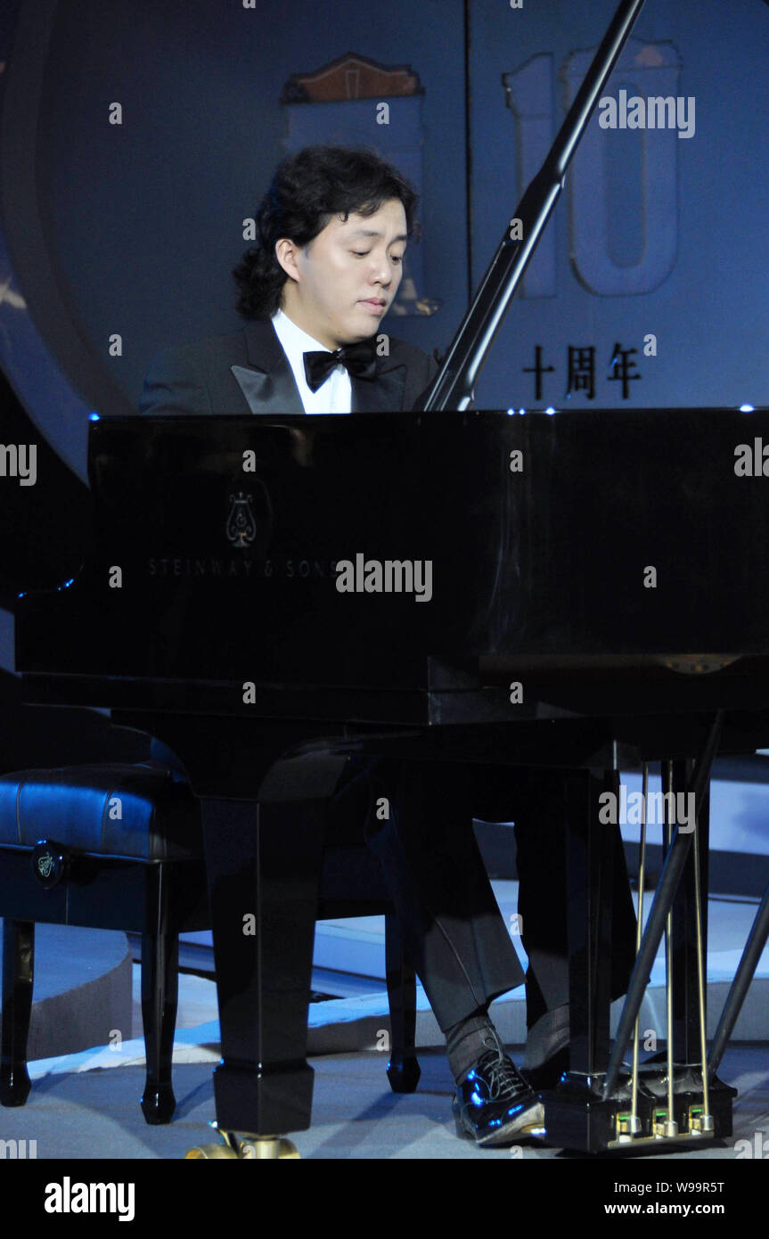 Chinese pianist Li Yundi performs at an exhibition celebrating the 10th ...