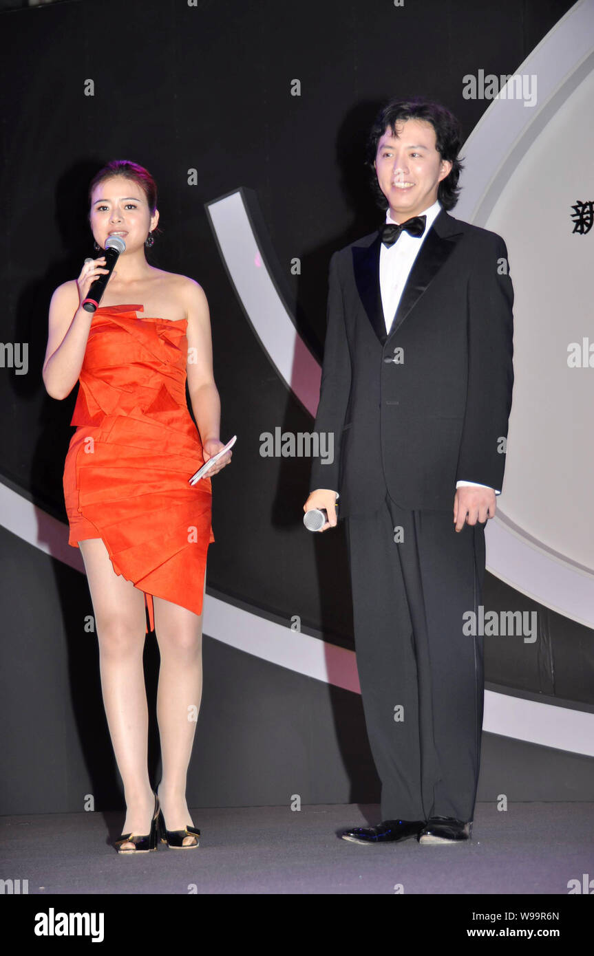 Chinese pianist Li Yundi (R) attends an exhibition celebrating the 10th ...