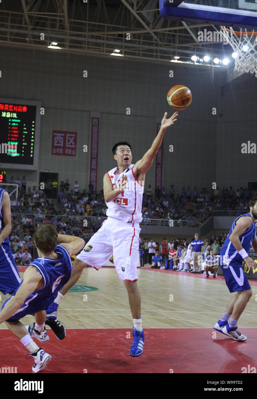 Chinese basketball player Wang Zhizhi(front center) shoots during the ...