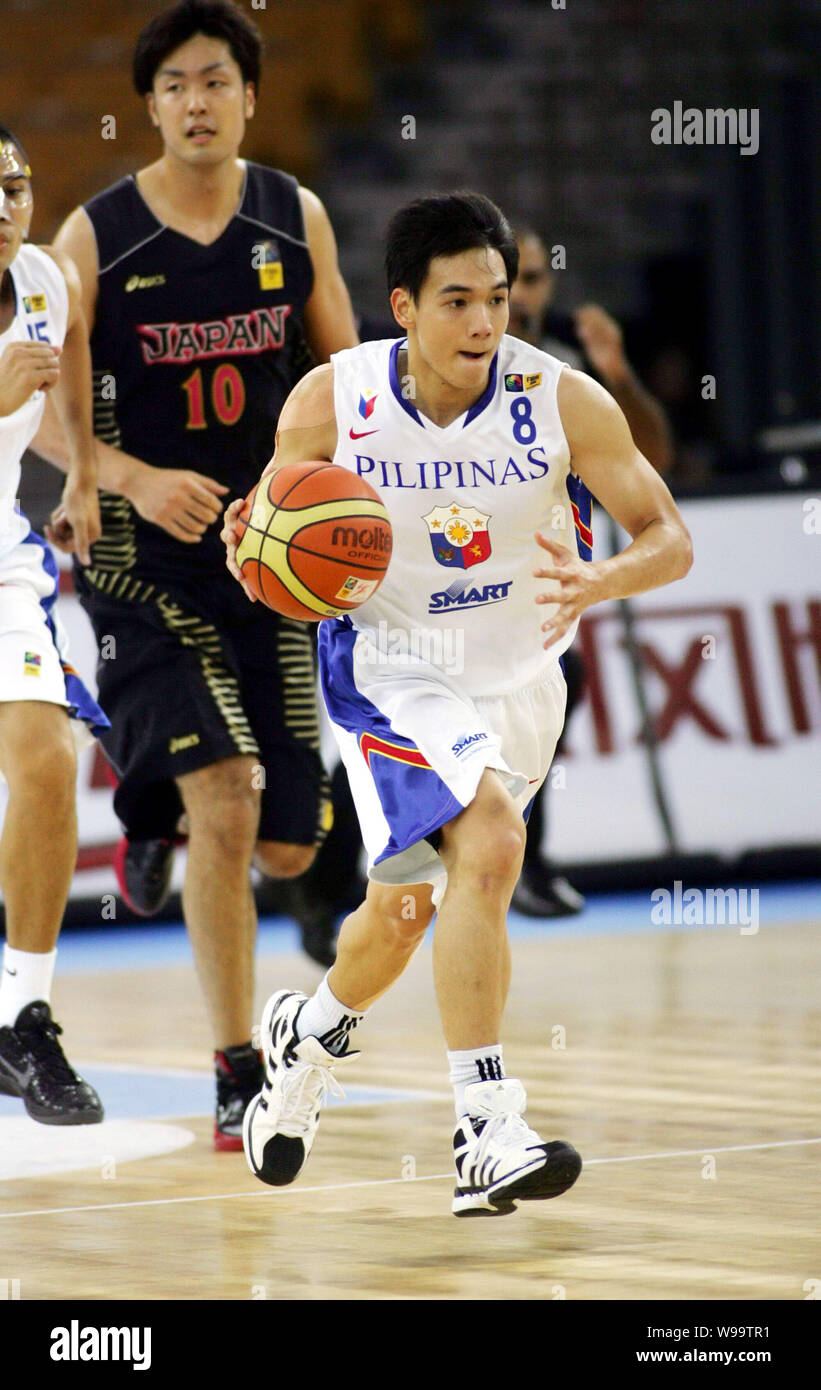 Christopher John Tiu of the Philippines, front, dribbles against Japan ...