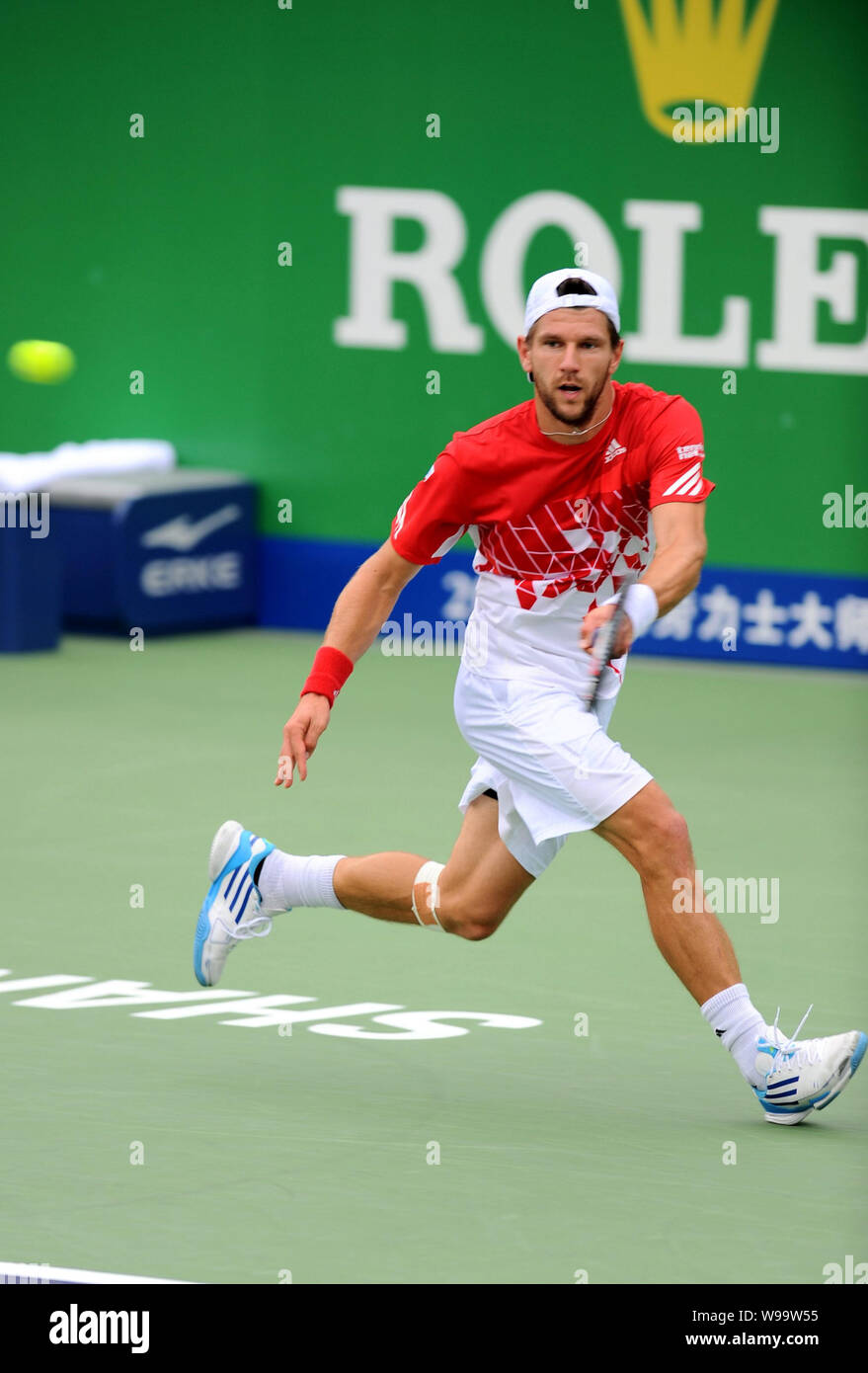 Jurgen Melzer of Austria returns a shot against Santiago Giraldo of ...