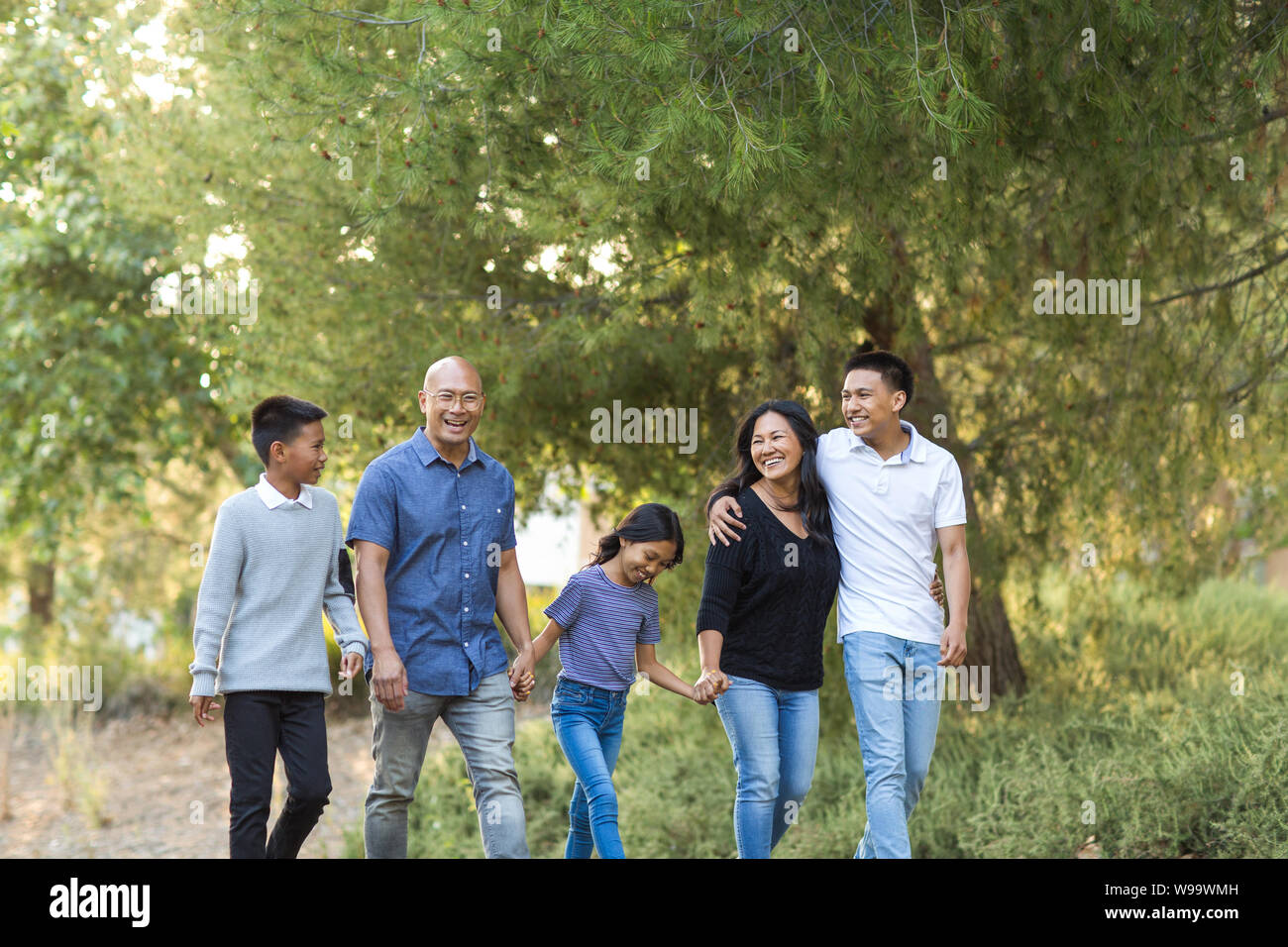Happy Asian family walking and talking outside Stock Photo - Alamy