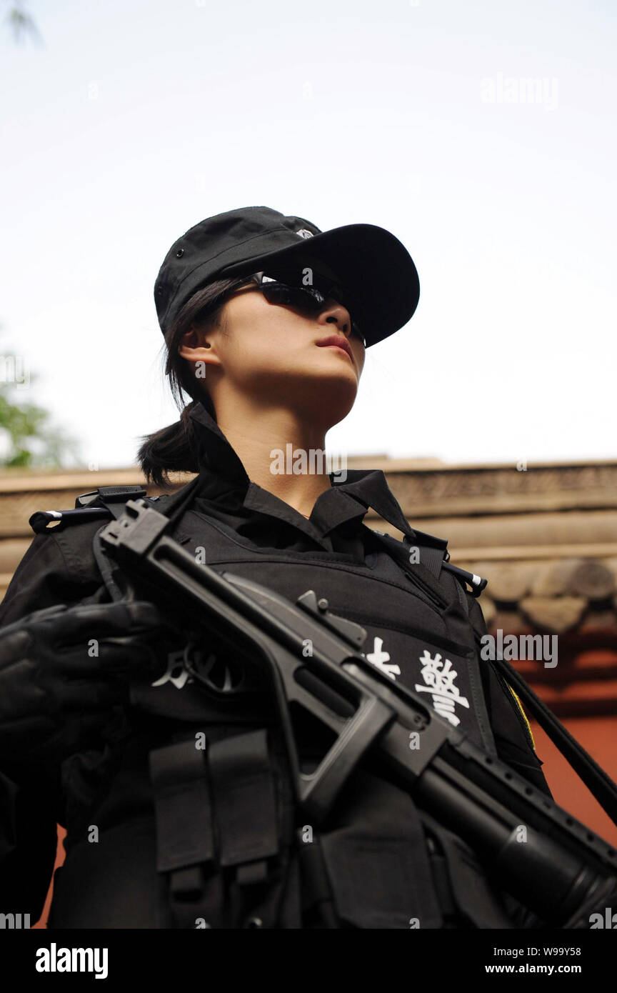 A Chinese special policewoman patrols a street in Chengdu city ...