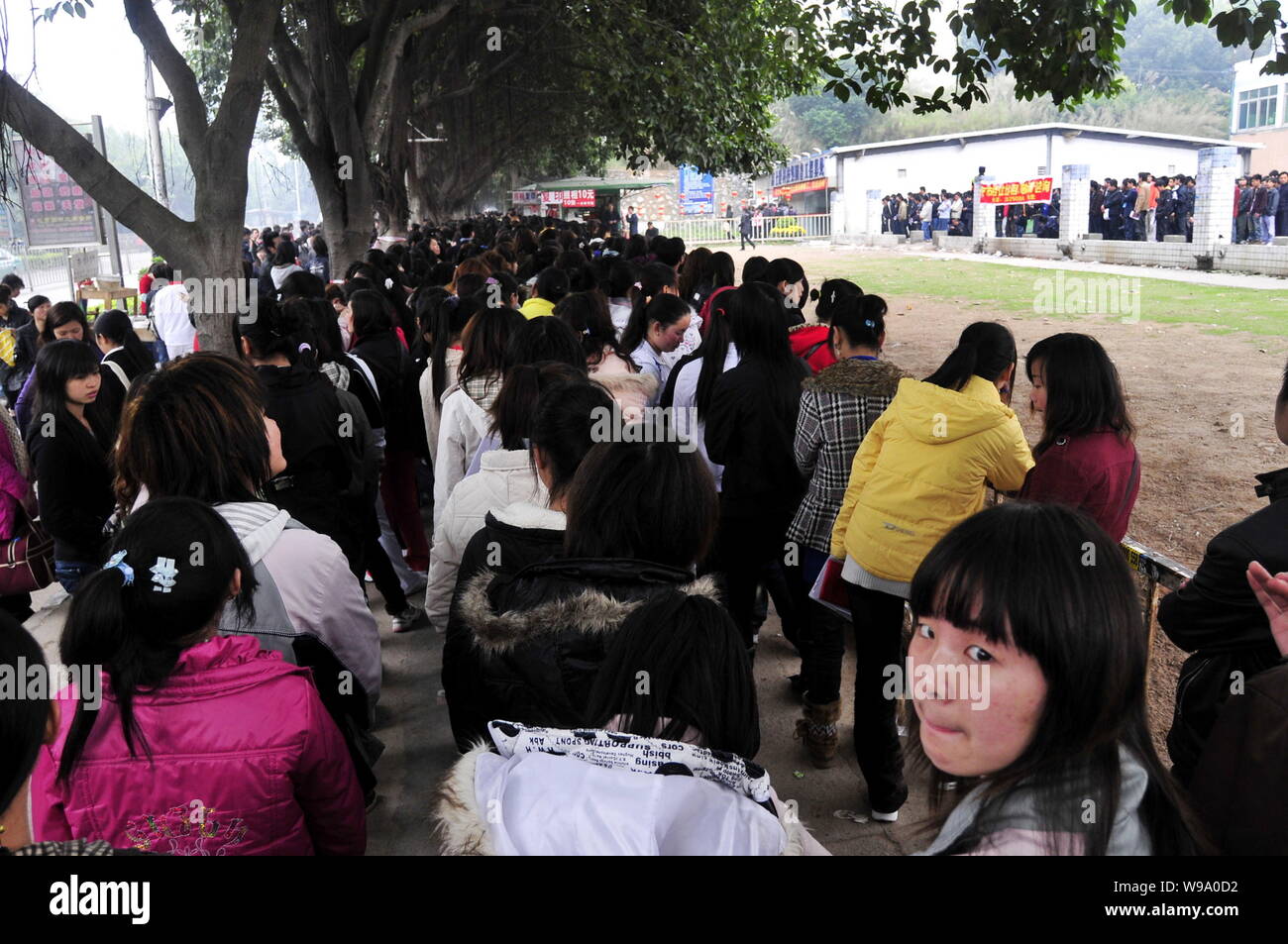 Crowds of job seekers queue up to apply for jobs during a recruitment ...
