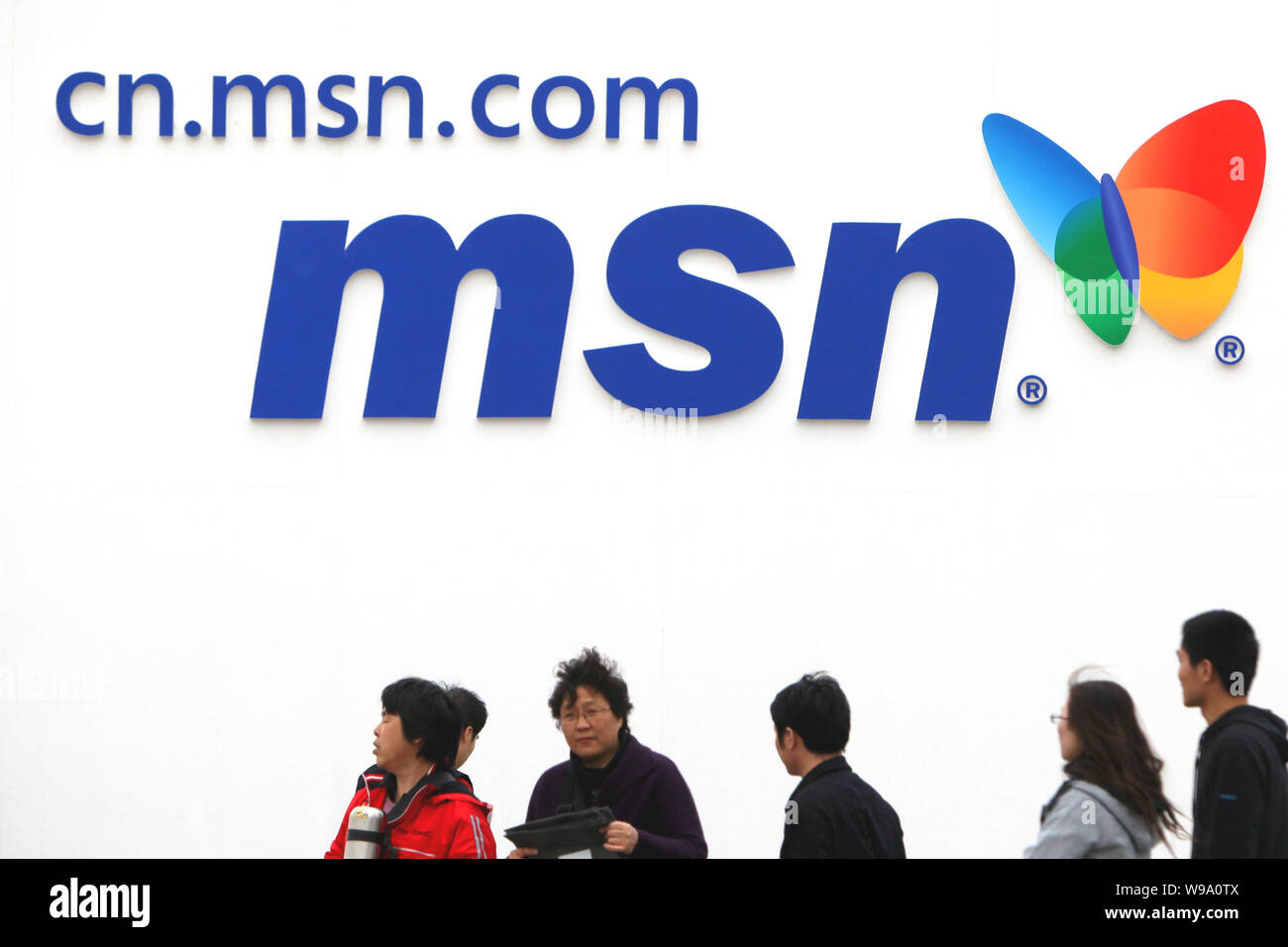 Local residents walk past an advertisement of MSN in Beijing, China ...