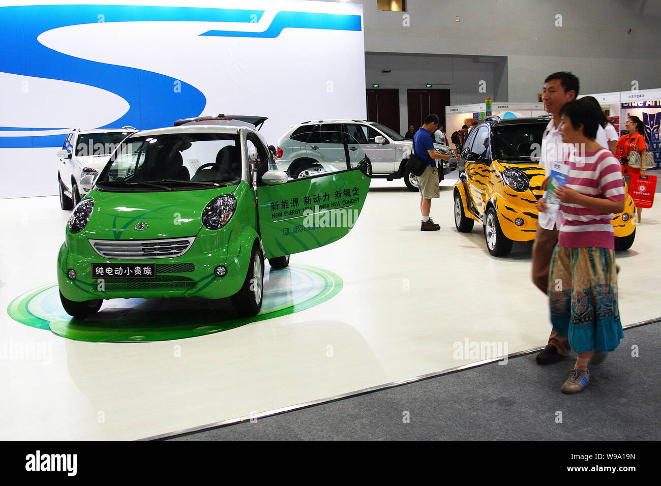 Visitors look at a Shuanghuan Noble electric car during the Automotive ...