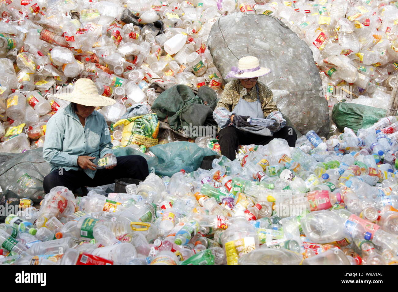 --FILE--Chinese workers clean up waste plastic bottles at a recycling ...