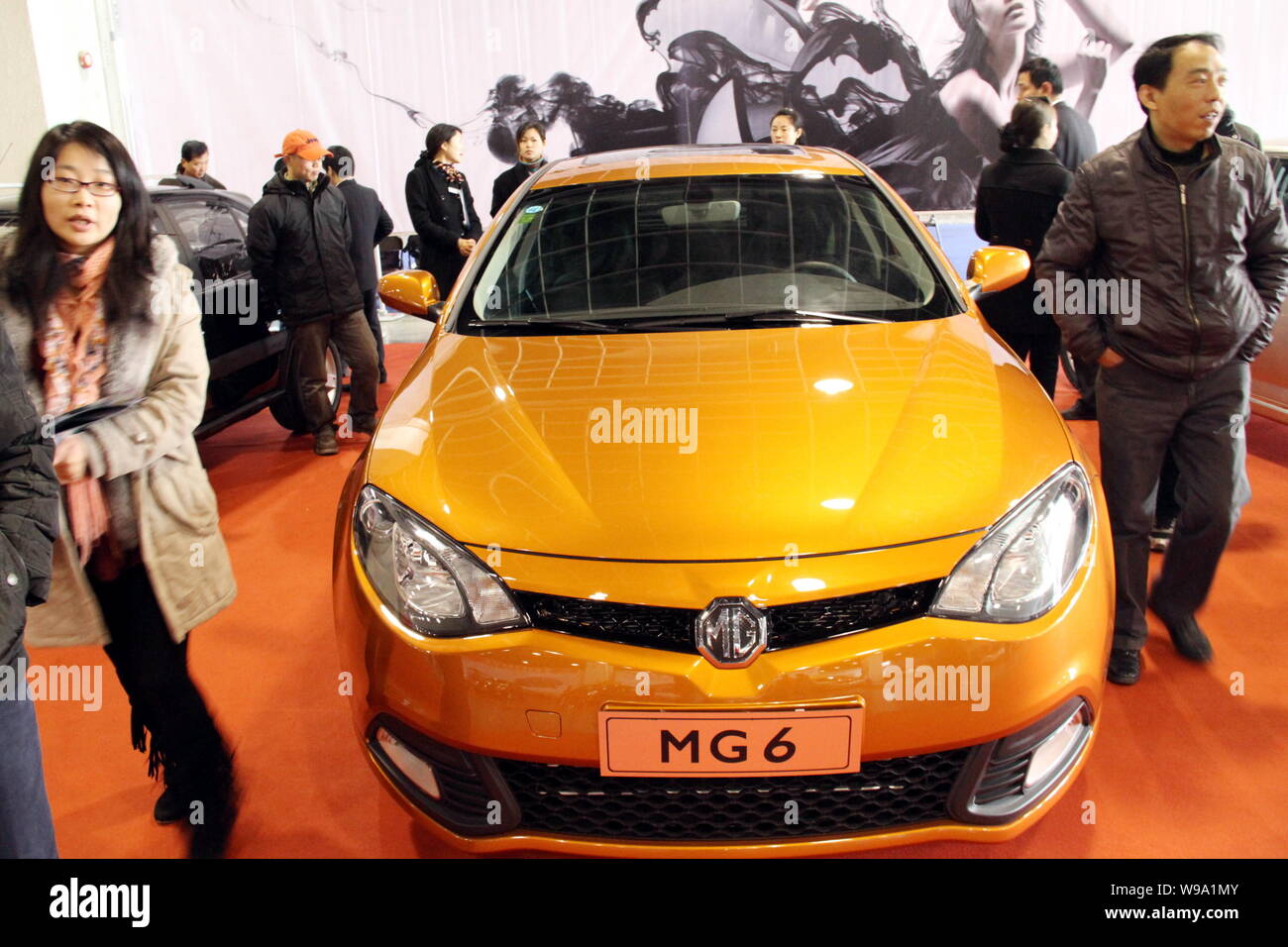 --FILE--Chinese visitors look at an MG6 of SAIC Motor during an auto show in Nanjing city, east ...