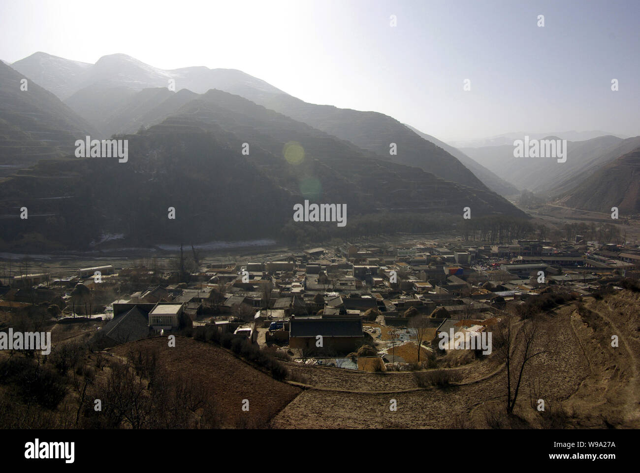 Xiaozhai villager is seen surrounded by mountains in Min county, Dingxi ...