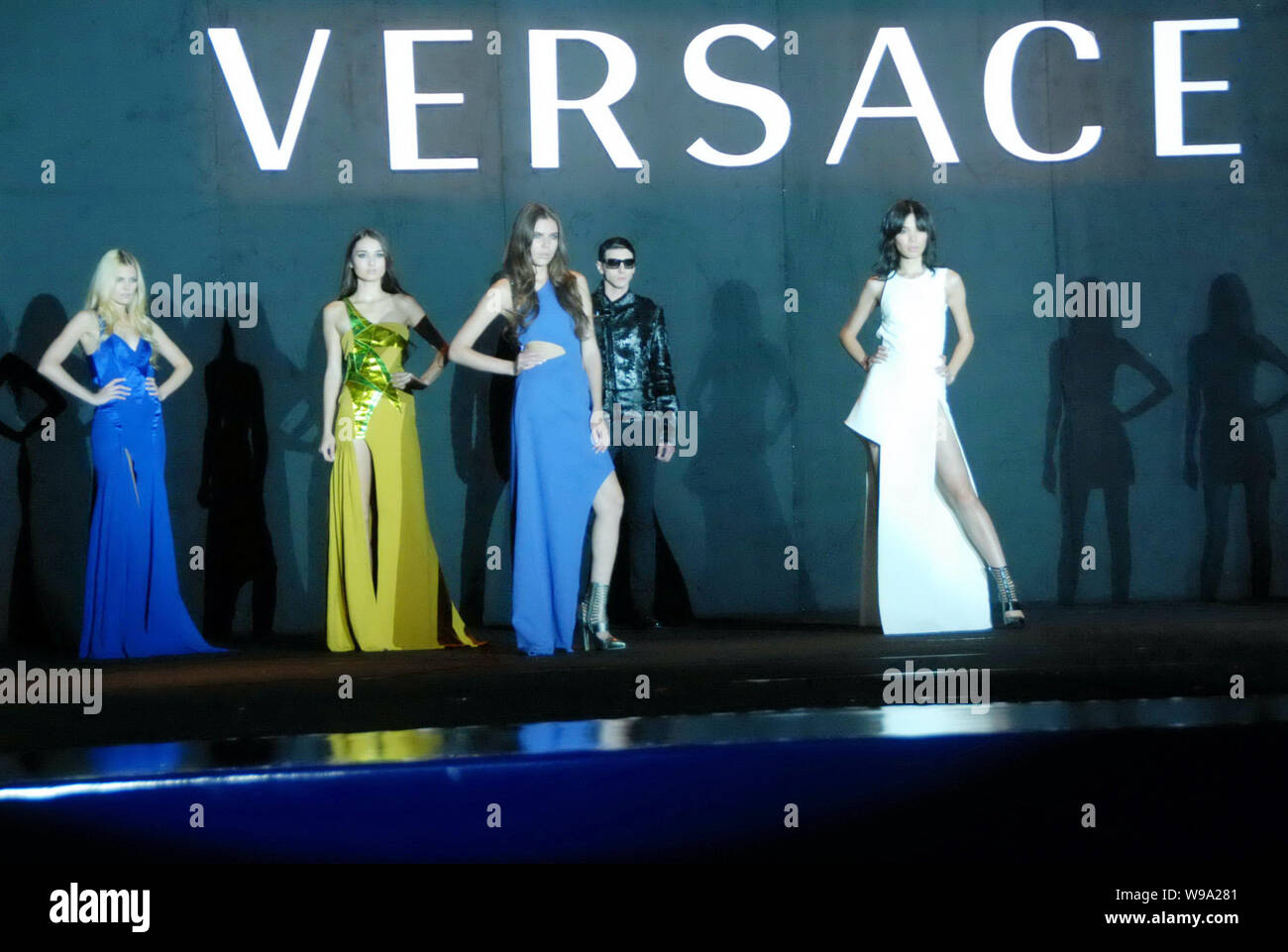 Models pose to show new collections at a Versace fashion show during ...