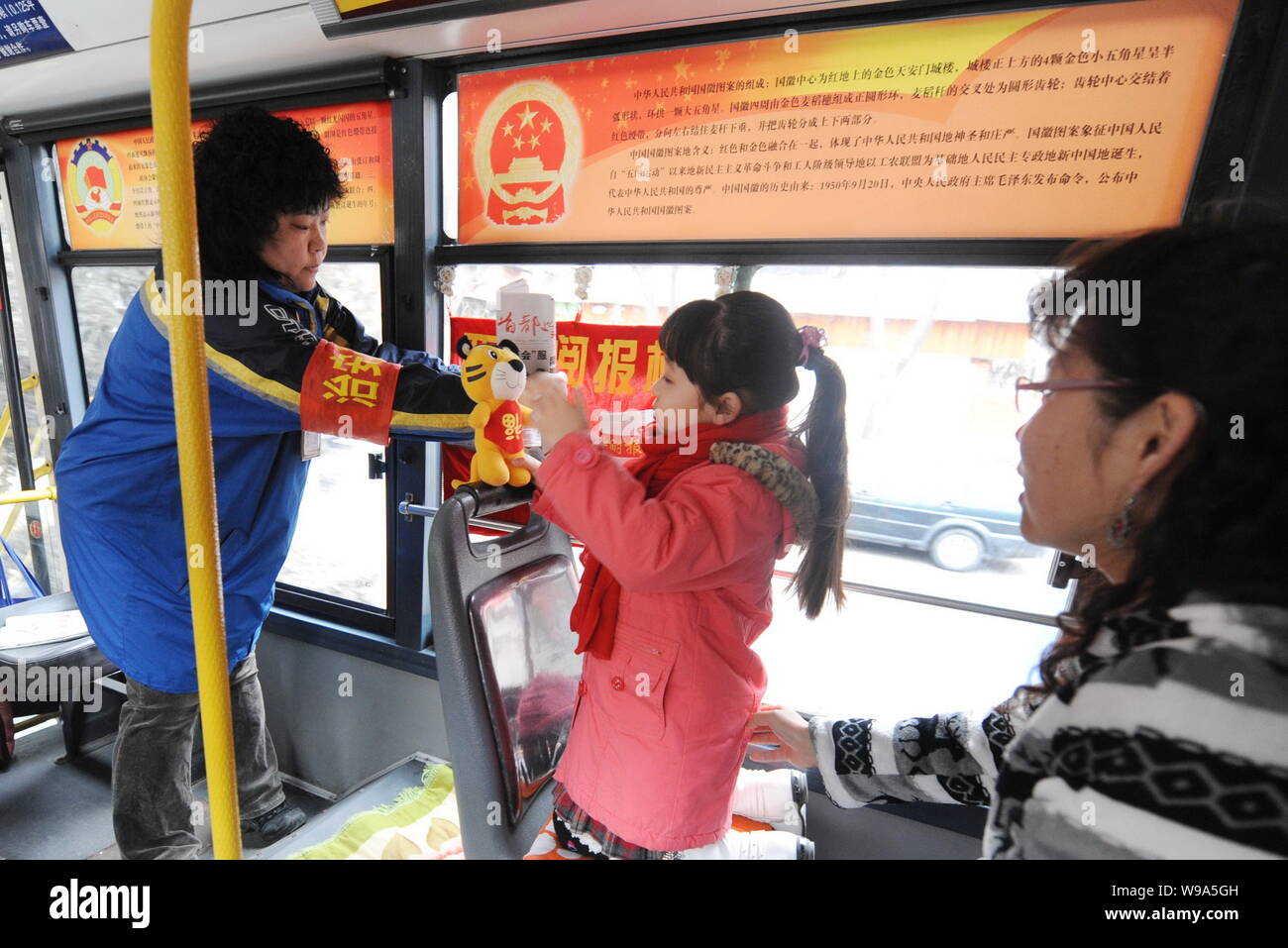 --FILE-- A ticket seller serves a passenger on a bus in Beijing, China ...
