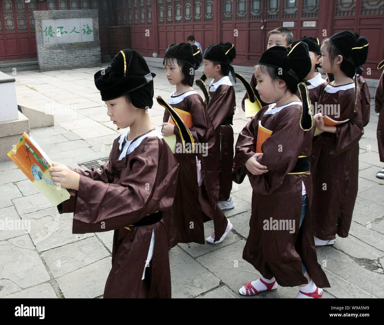 Chinese Grade One pupils wearing traditional student uniforms arrive ...