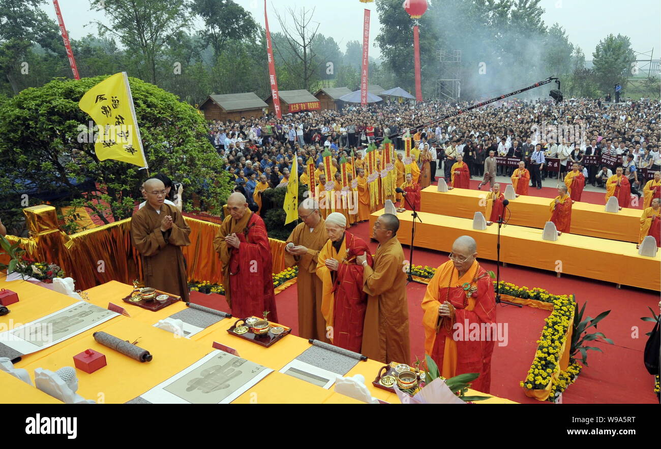 Chinese Buddhist monks pray during a ceremony for regilding a Buddha ...