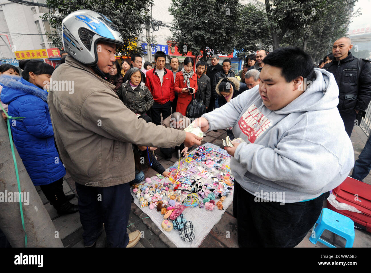 Chinas fattest man Liang Yong sells goods on a street in Chongqing ...