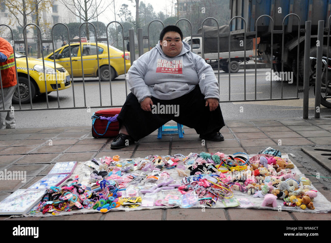 Chinas fattest man Liang Yong sells goods on a street in Chongqing ...