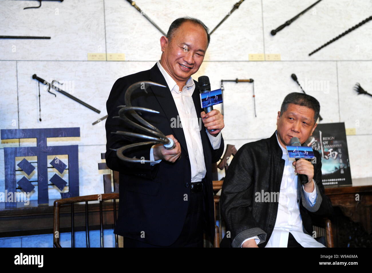 Hong Kong director John Woo (left) tries an ancient weapon to promote ...