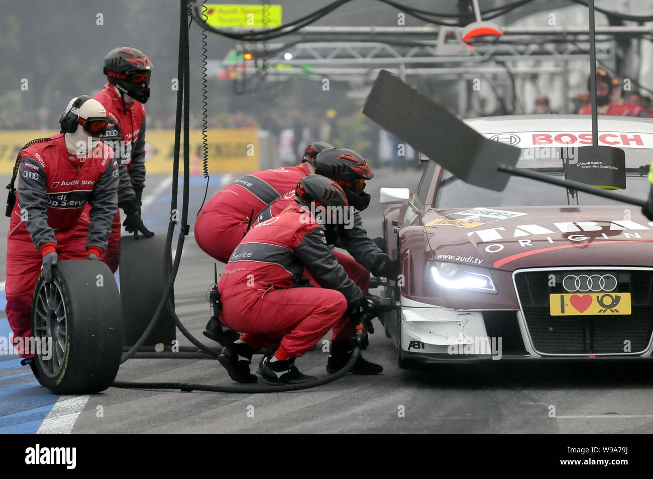 Service staff change tiers for the racing car of British racer Oliver ...