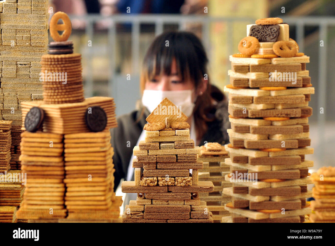 A volunteer is building a model of Shanghai with about 10,000 pieces of ...