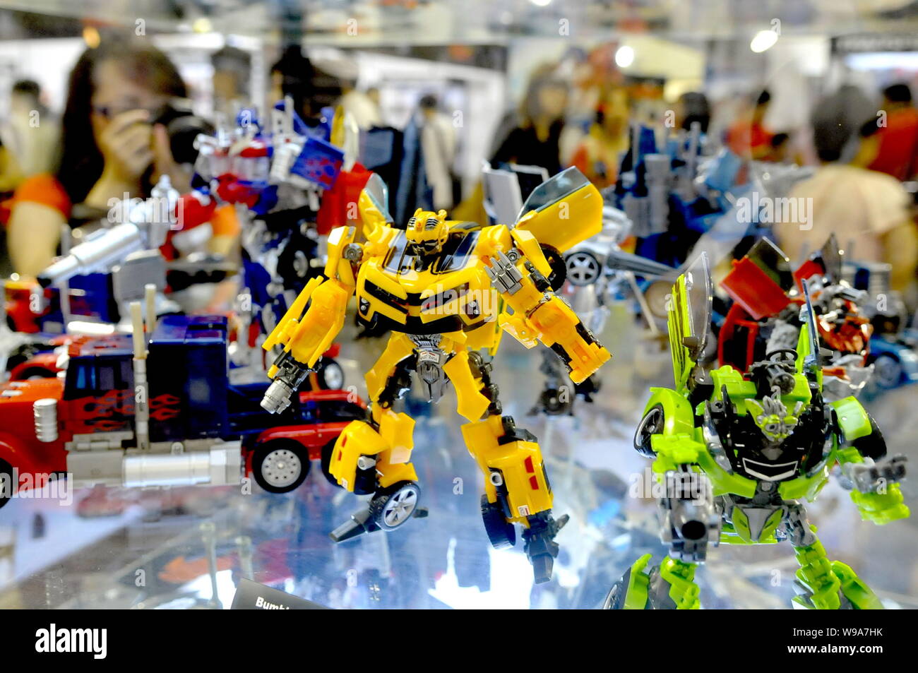 Visitors look at models of the Transformers during the 2010 ...