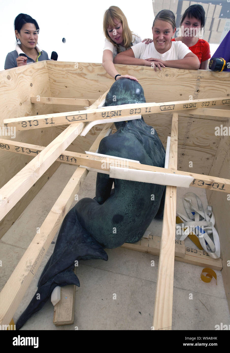 Staff of the Denmark Pavilion look at the Little Mermaid statue before ...