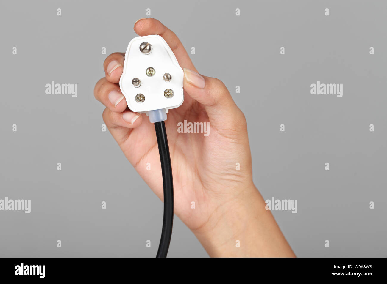 Hand holding a plug in hi-res stock photography and images - Alamy
