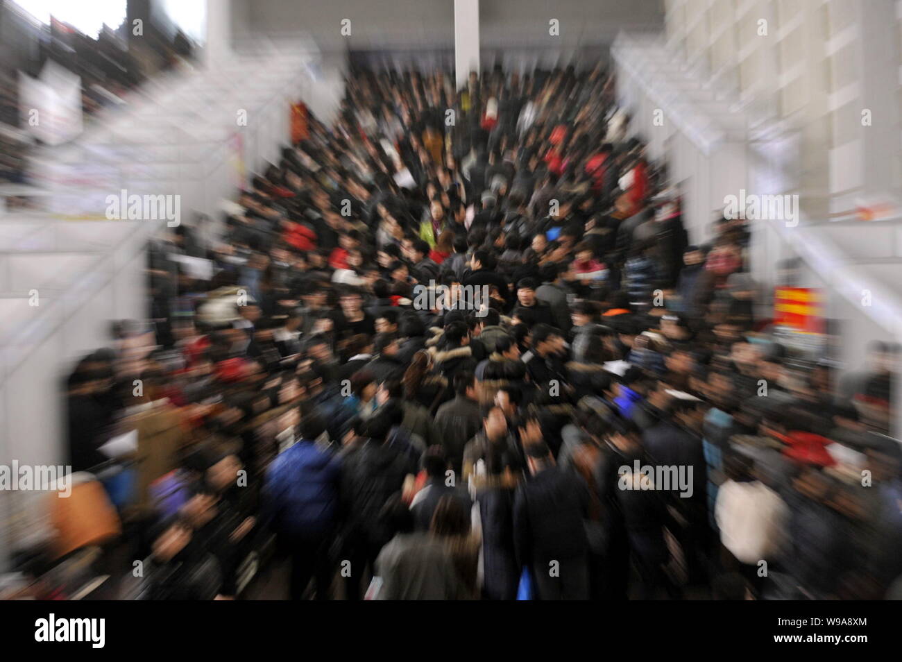 Chinese job seekers crowd booths at a job fair in Shenyang city ...