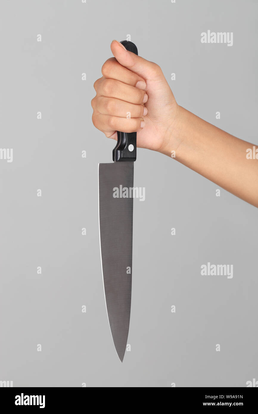 Close up of a person hand holding kitchen knife Stock Photo - Alamy
