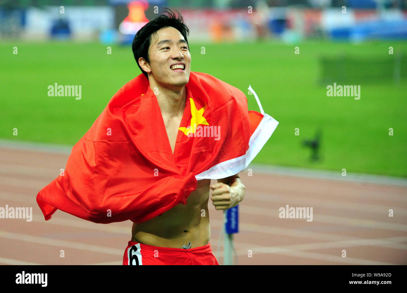 Chinas star hurdler Liu Xiang celebrates after winning the mens 110m ...