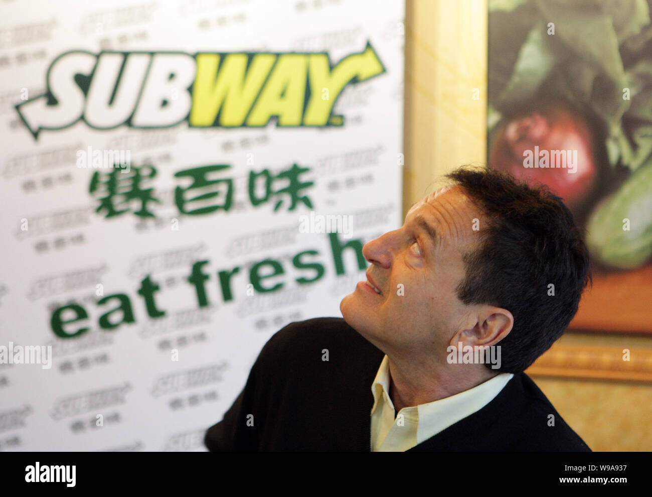 Fred DeLuca, President of Subway, looks at the logo of Subway at a ...