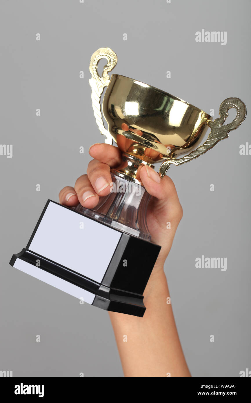 Close up of person hand showing trophy Stock Photo - Alamy