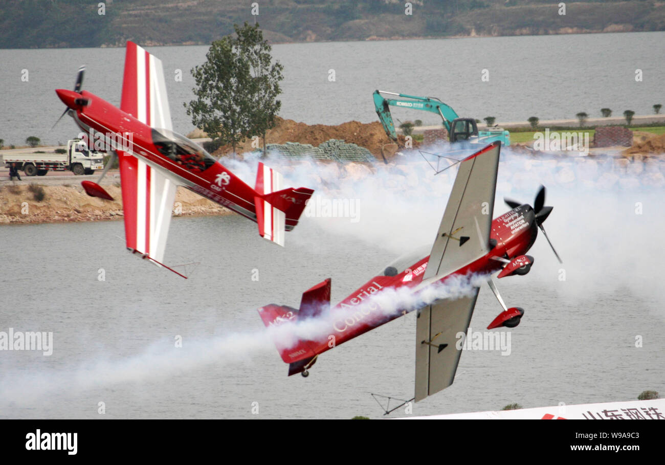 Two planes fly by each other during the opening ceremony of the 2010 ...