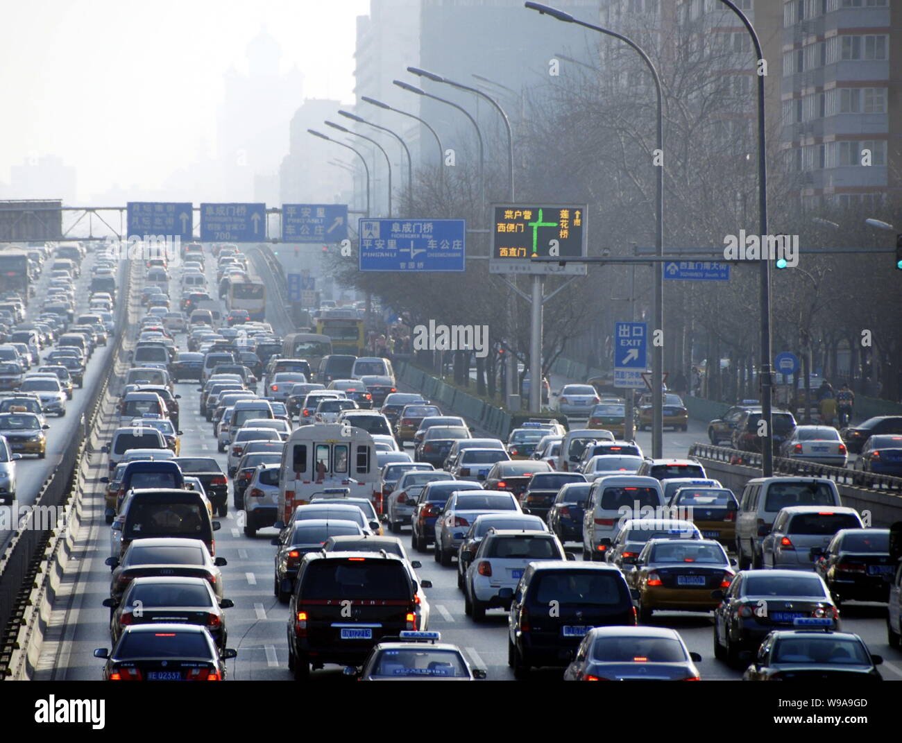 --FILE--Masses of cars and buses drive on a street in Beijing, China ...
